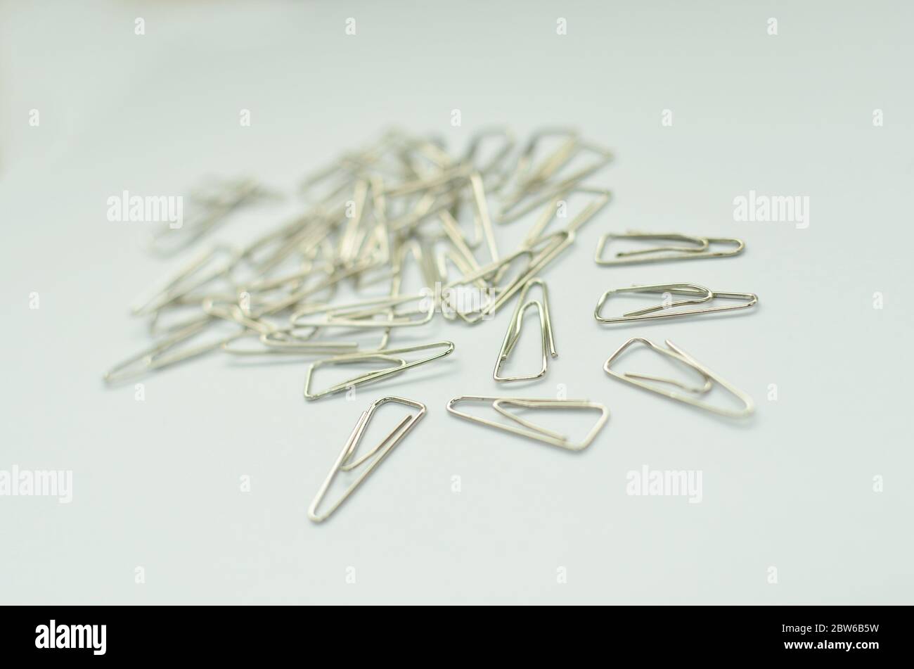 Office, paper clip on white background Stock Photo - Alamy