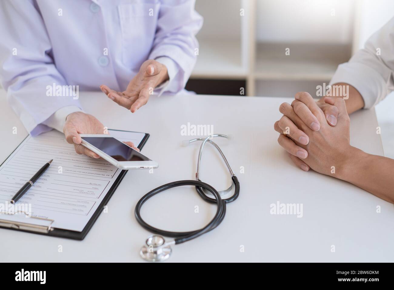 doctor giving consulting and diagnostic to patient and explaining ...