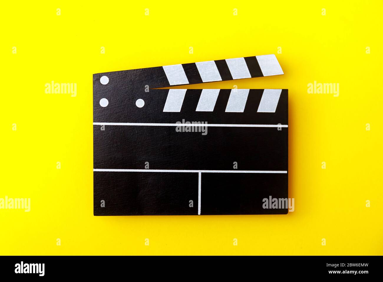 Cinema black clapperboard on yellow background. Modern cinematography ...