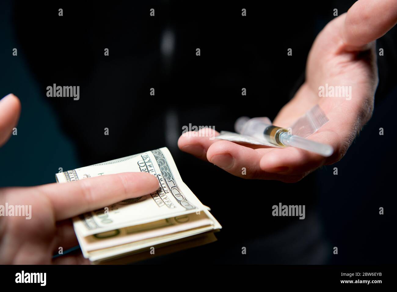 Close-up of hands about to exchange money for a dose of drugs. Dealer ...