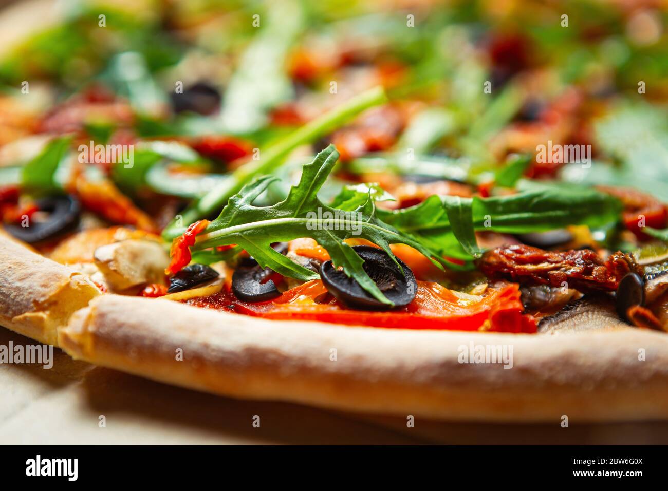 Delicious Italian pasta with arugula leaves,black olives and dried ...