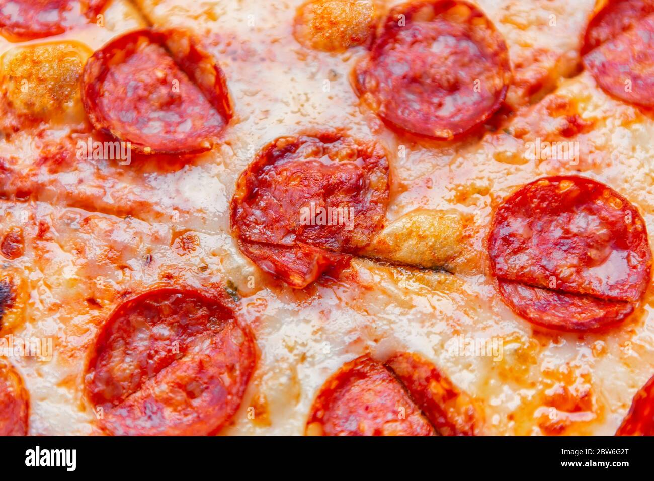 Pepperoni pizza texture in close up.Delicious spicy Italian fast food ...