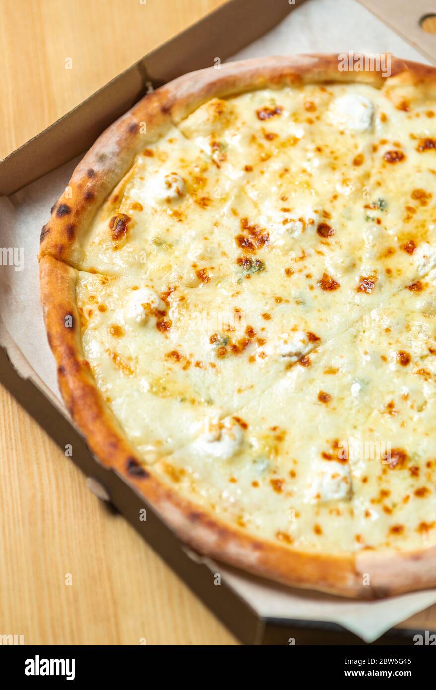 Cheese pizza delivery.Delicious cheesy fast food delivered in cardboard ...
