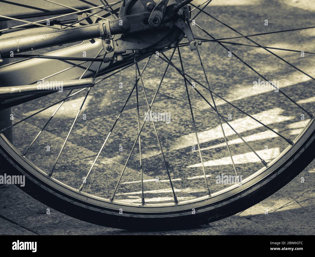 Vintage bicycle wheel on the pavement Stock Photo - Alamy