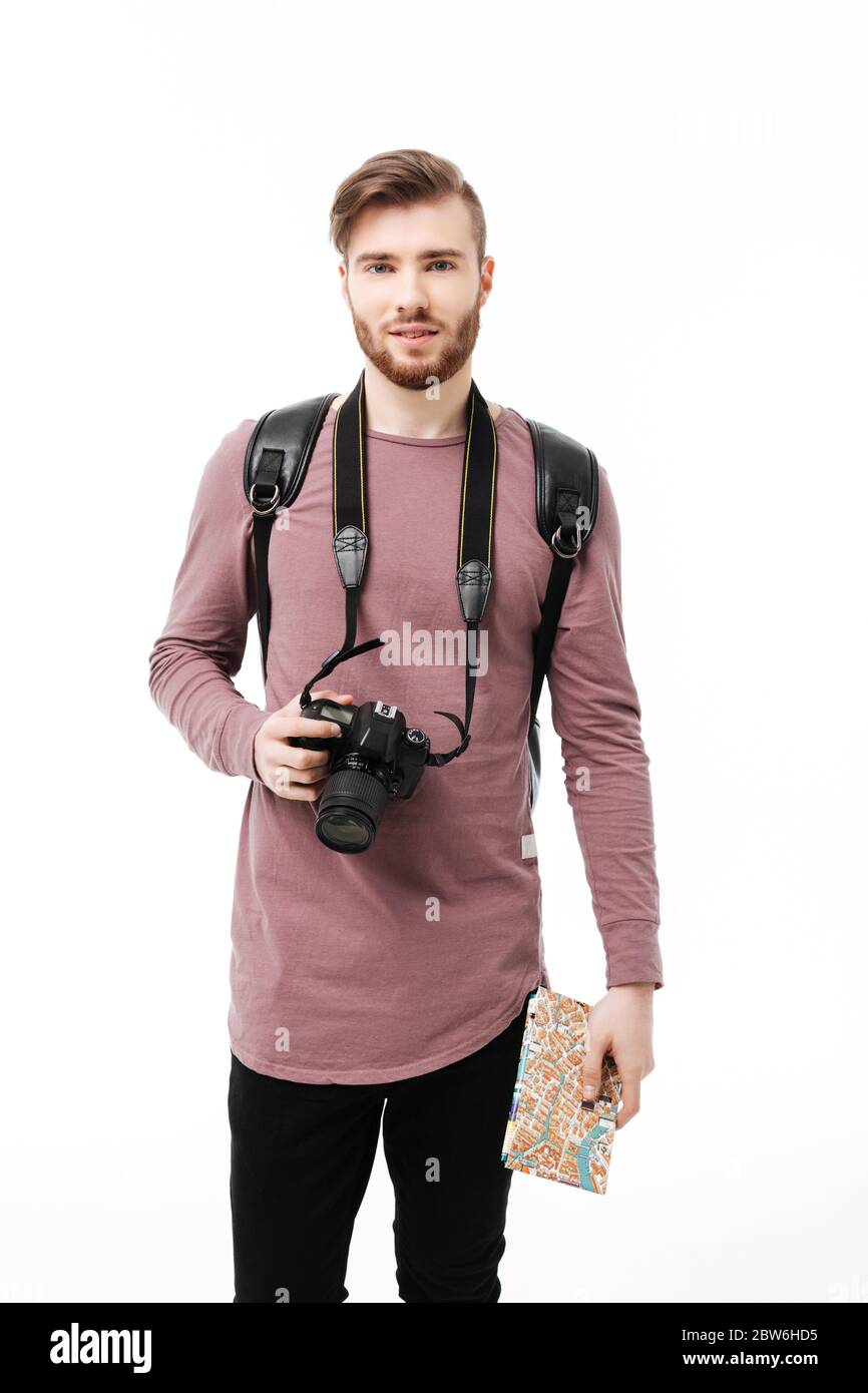 Young smiling man standing with camera and map in hands Cool boy ...