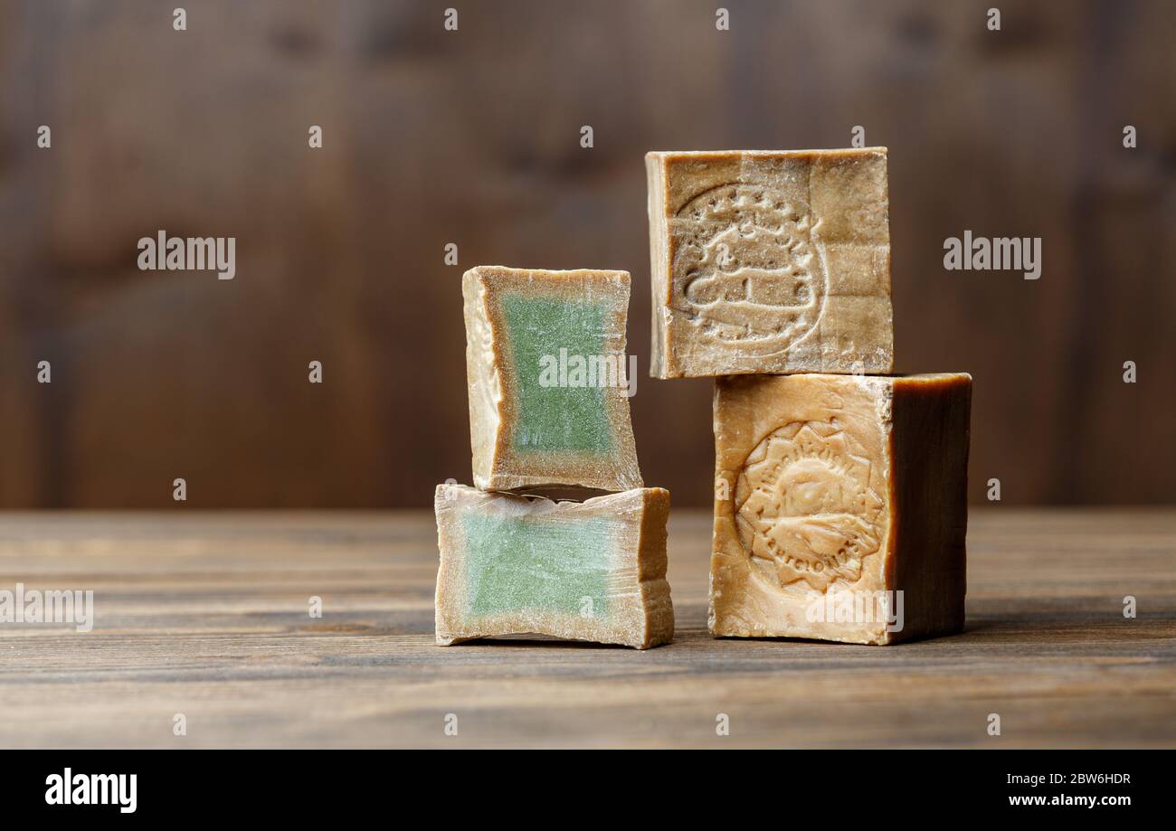Two bars and slices of traditional aleppo organic laurel soap on a ...