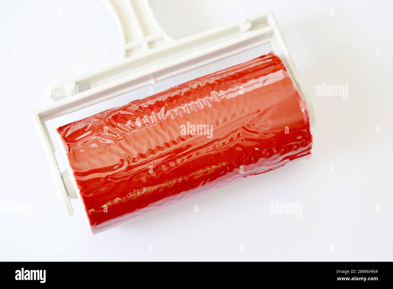 red sticky dust roller on white background Stock Photo - Alamy