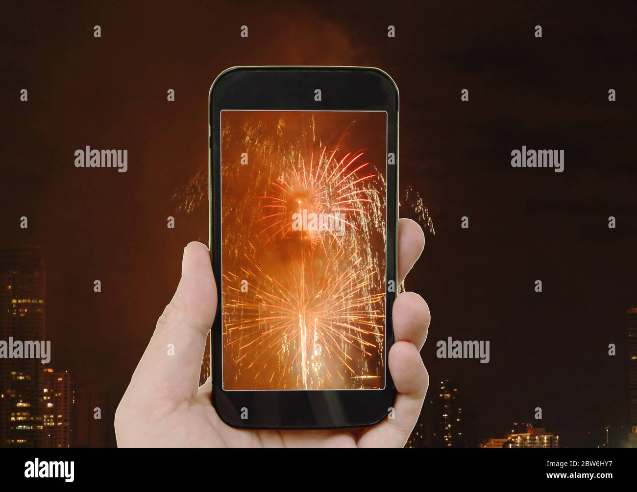 mobile phone holding in human hand with fireworks on screen Stock Photo ...