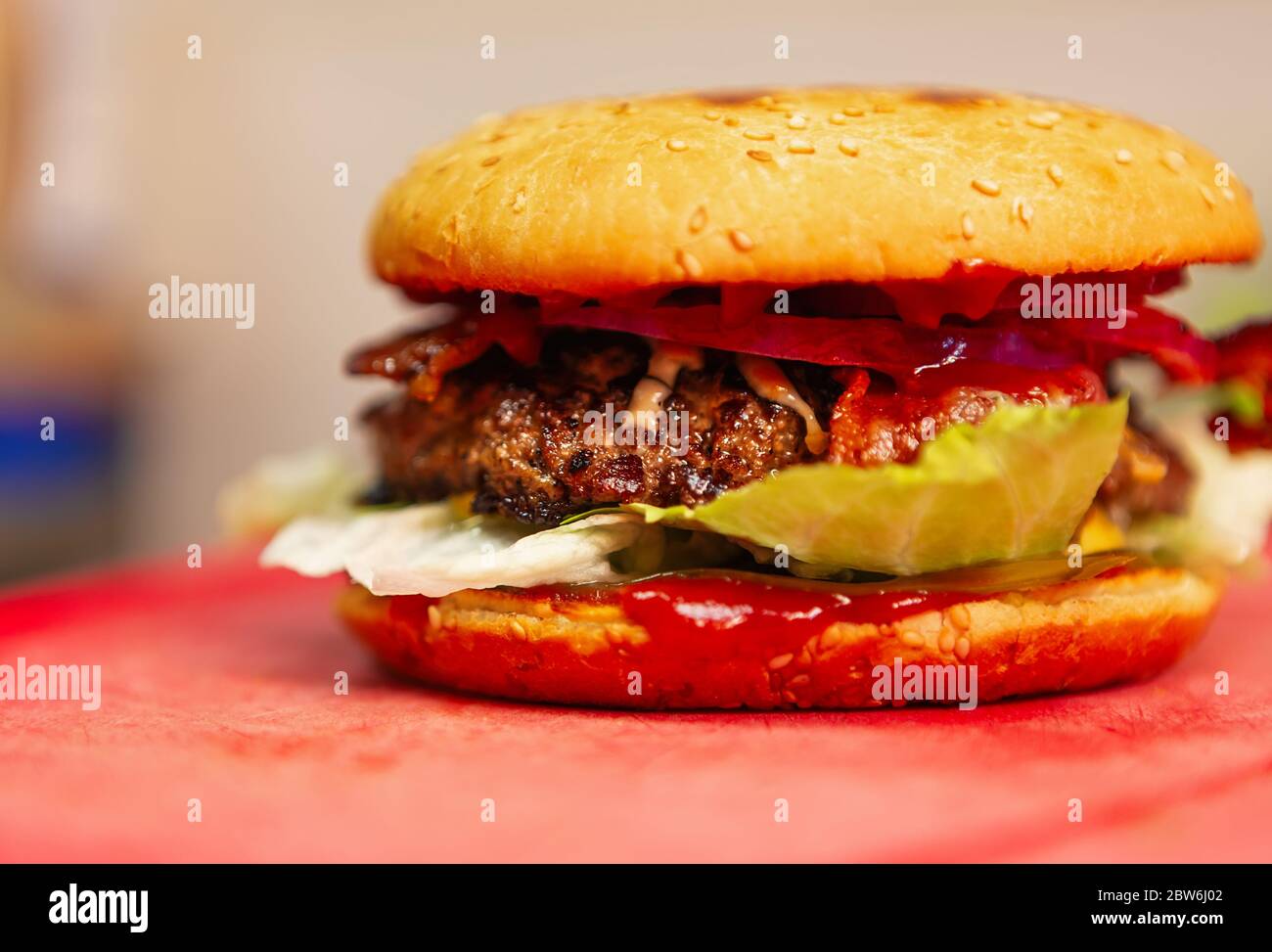 Big fat burger cooking in fat food restaurant kitchen in close up Stock ...