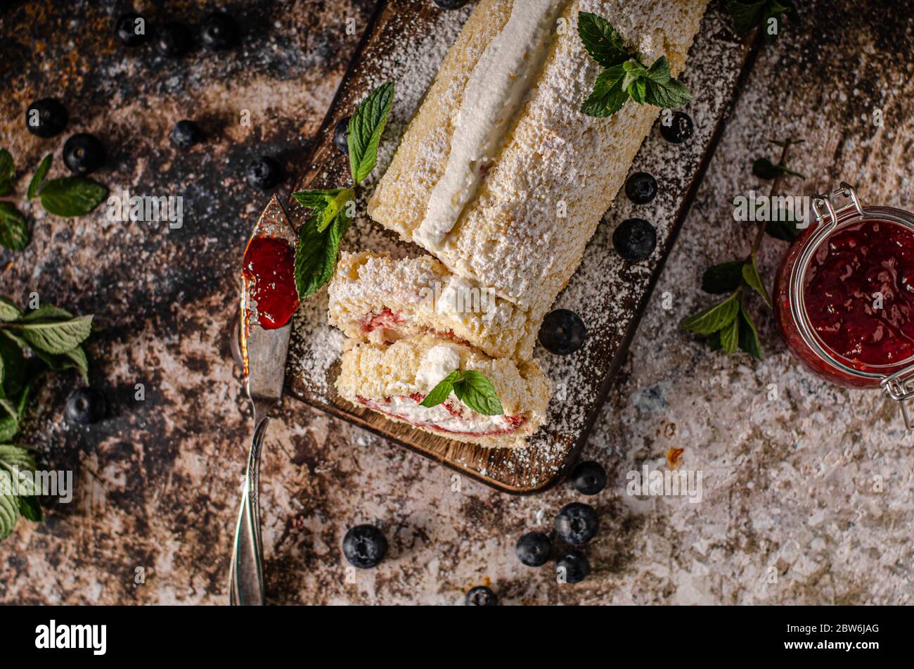 Sweet creamy roulade with berries, forest fruit and mint Stock Photo ...