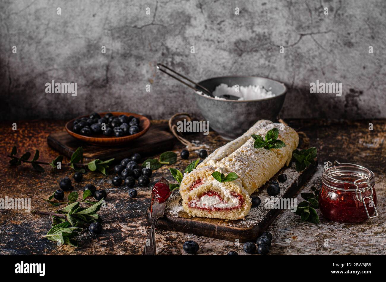 Sweet creamy roulade with berries, forest fruit and mint Stock Photo ...