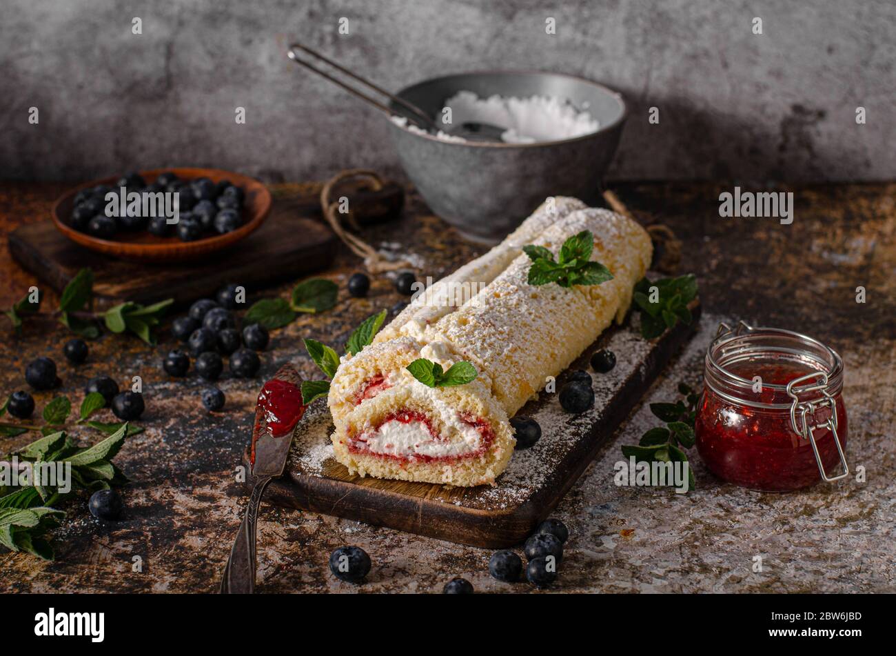 Sweet creamy roulade with berries, forest fruit and mint Stock Photo ...