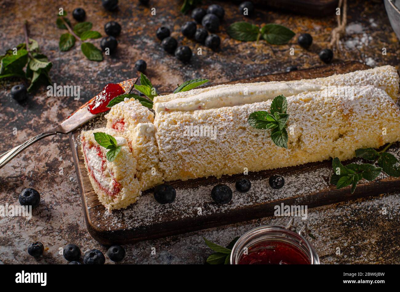 Sweet creamy roulade with berries, forest fruit and mint Stock Photo ...