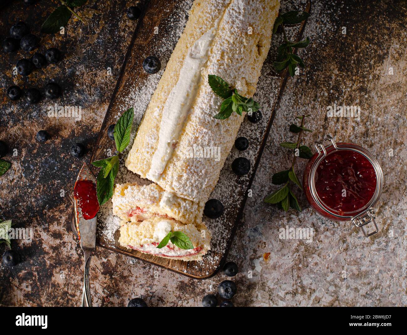 Sweet creamy roulade with berries, forest fruit and mint Stock Photo ...