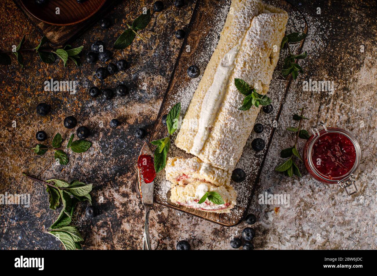 Sweet creamy roulade with berries, forest fruit and mint Stock Photo ...