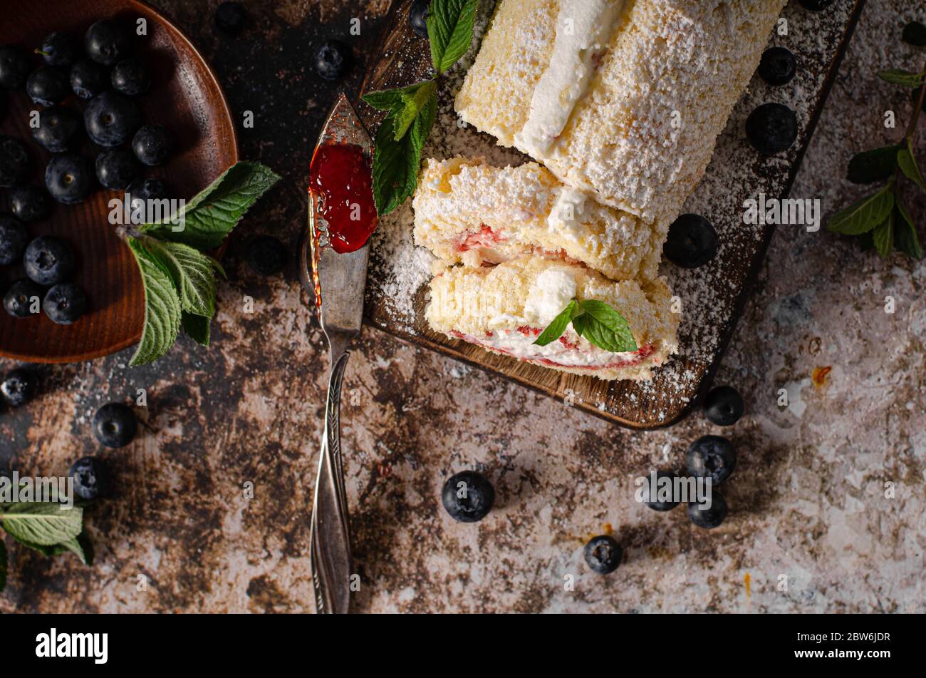 Sweet creamy roulade with berries, forest fruit and mint Stock Photo ...