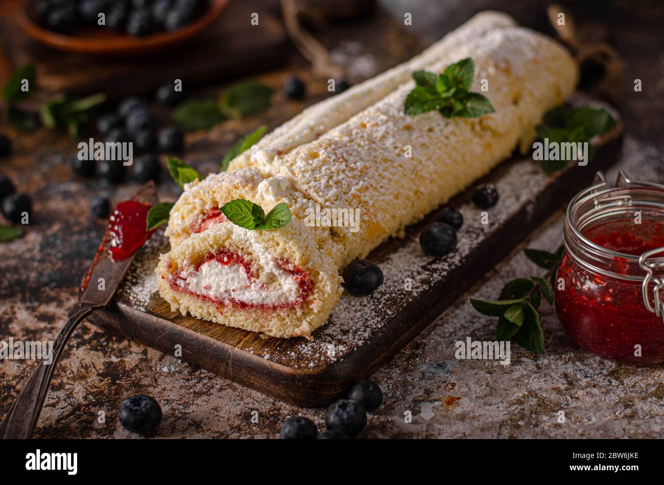 Sweet creamy roulade with berries, forest fruit and mint Stock Photo ...