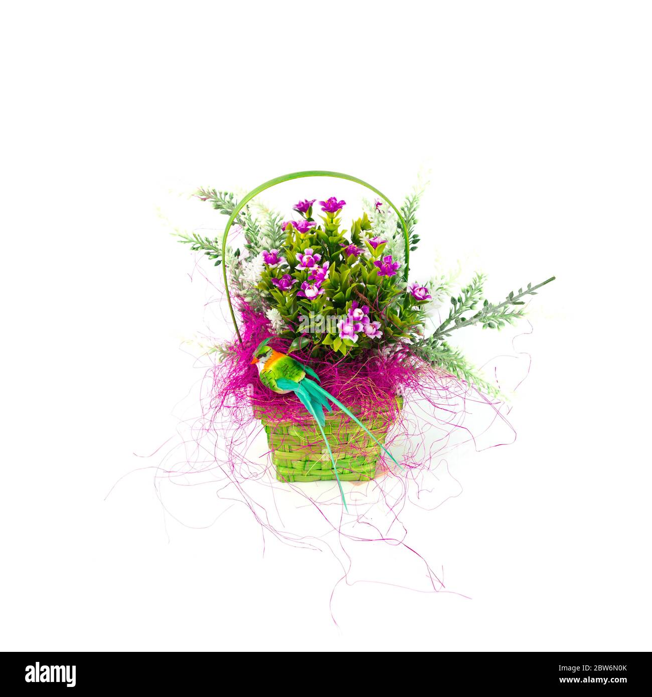 Composition with artificial flowers in a basket isolated on white ...