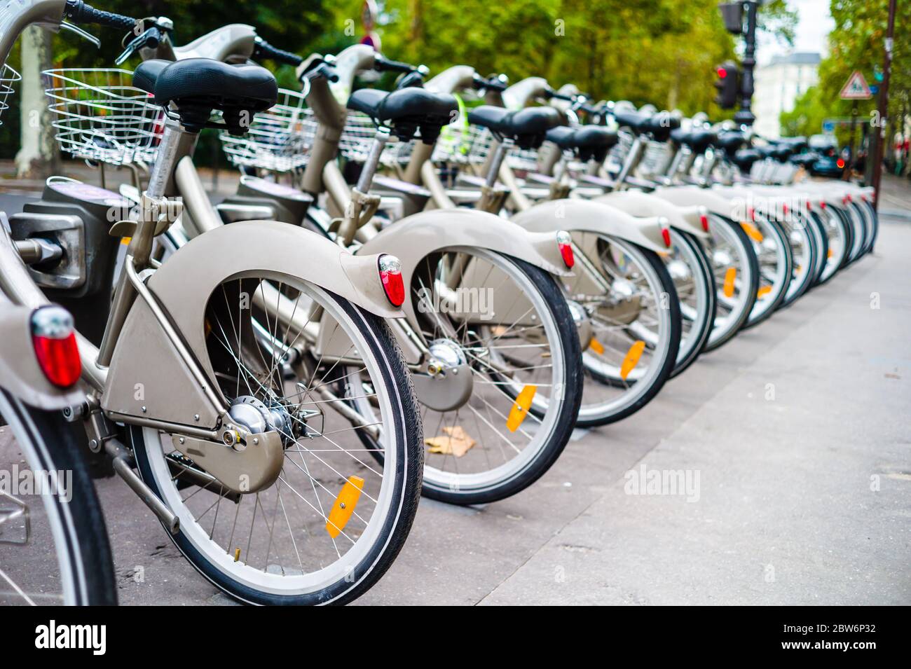 A fleet of shared bicycles neatly lined-up in a row at a docking ...