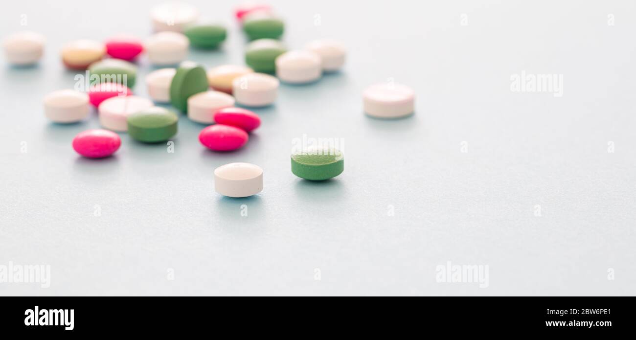 Medicine pills on blue pastel background. Colorful variation of ...