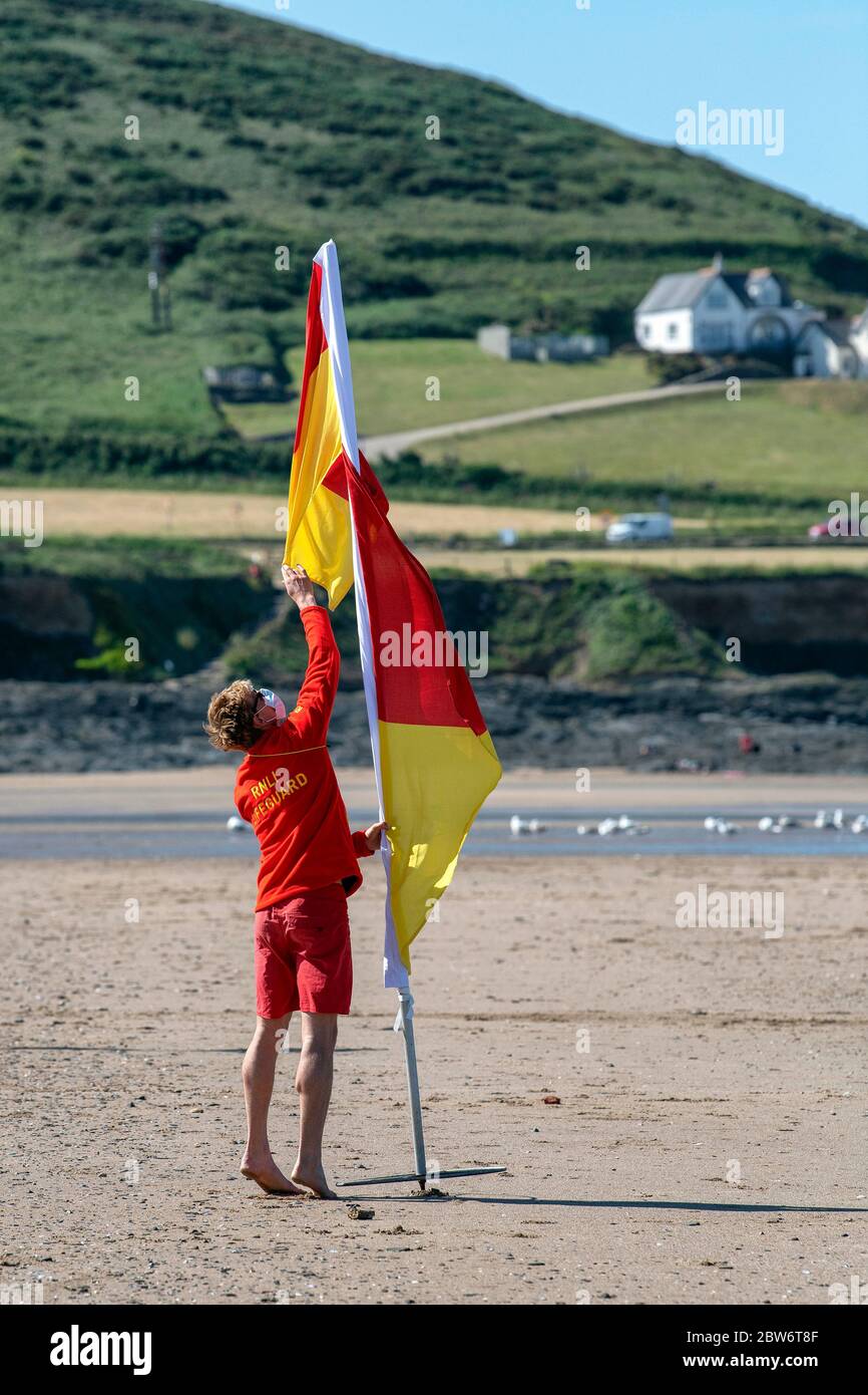 RNLI Lifeguards resume patrols on the beach at Croyde in Devon wearing ...