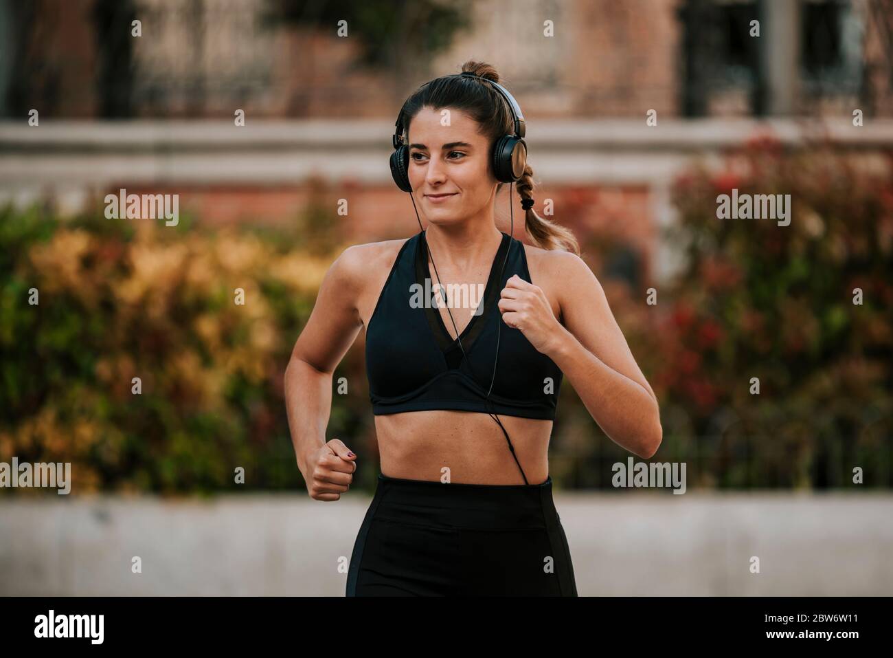 Woman runner wearing medical mask. Running in the park. Coronavirus ...