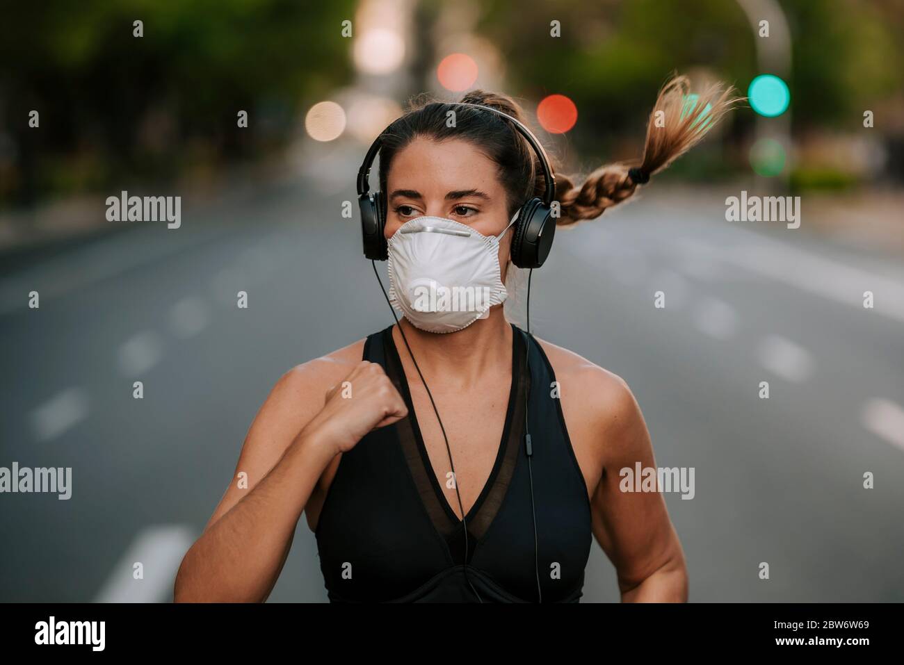 Woman runner wearing medical mask. Running in the park. Coronavirus ...