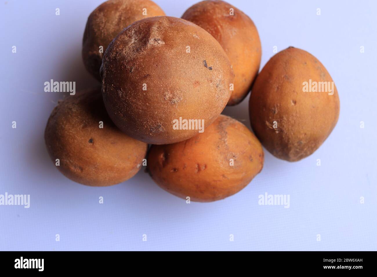 Ripe fresh sapota fruits isolated on white background Stock Photo - Alamy