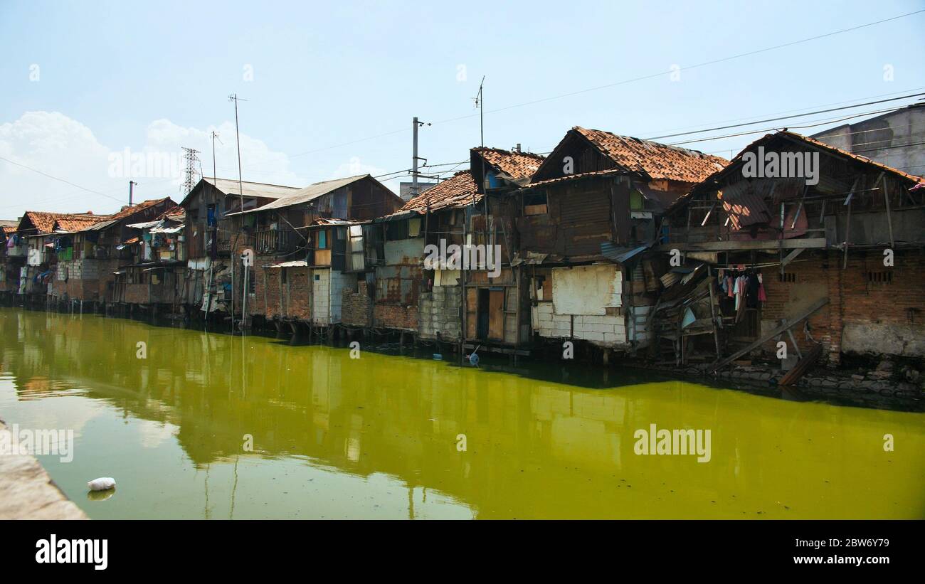 Slum area on the riverbank in Jakarta. Indonesia Stock Photo - Alamy