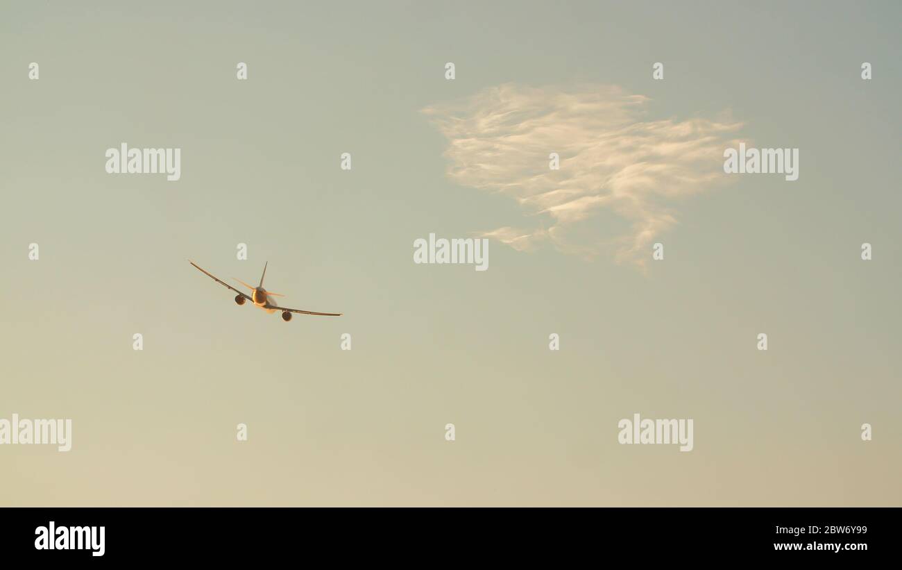 Passenger airplane takes off against the sky with silver clouds Stock ...