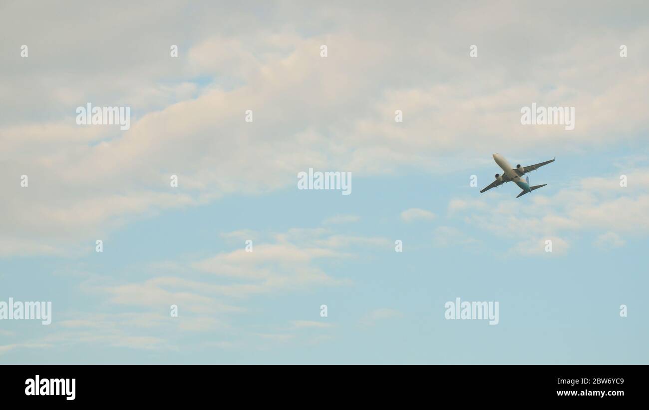 Passenger airplane takes off against the blue sky with clouds Stock ...