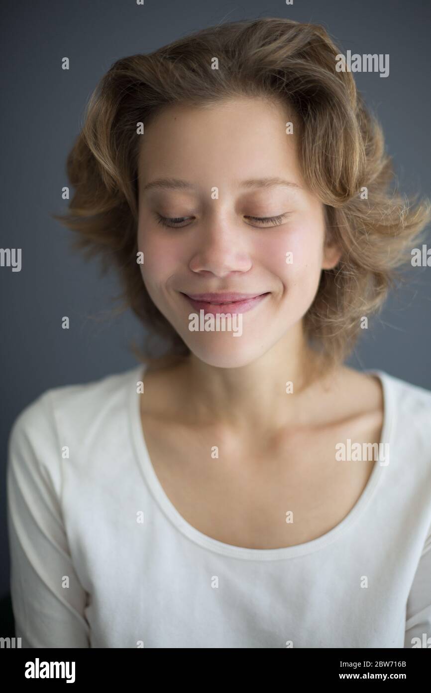 Portrait of smiling beautiful woman happily looking down Stock Photo ...