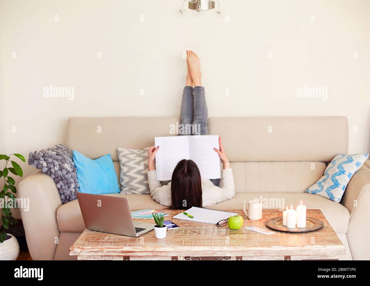 Woman lying on back legs up hi-res stock photography and images - Alamy