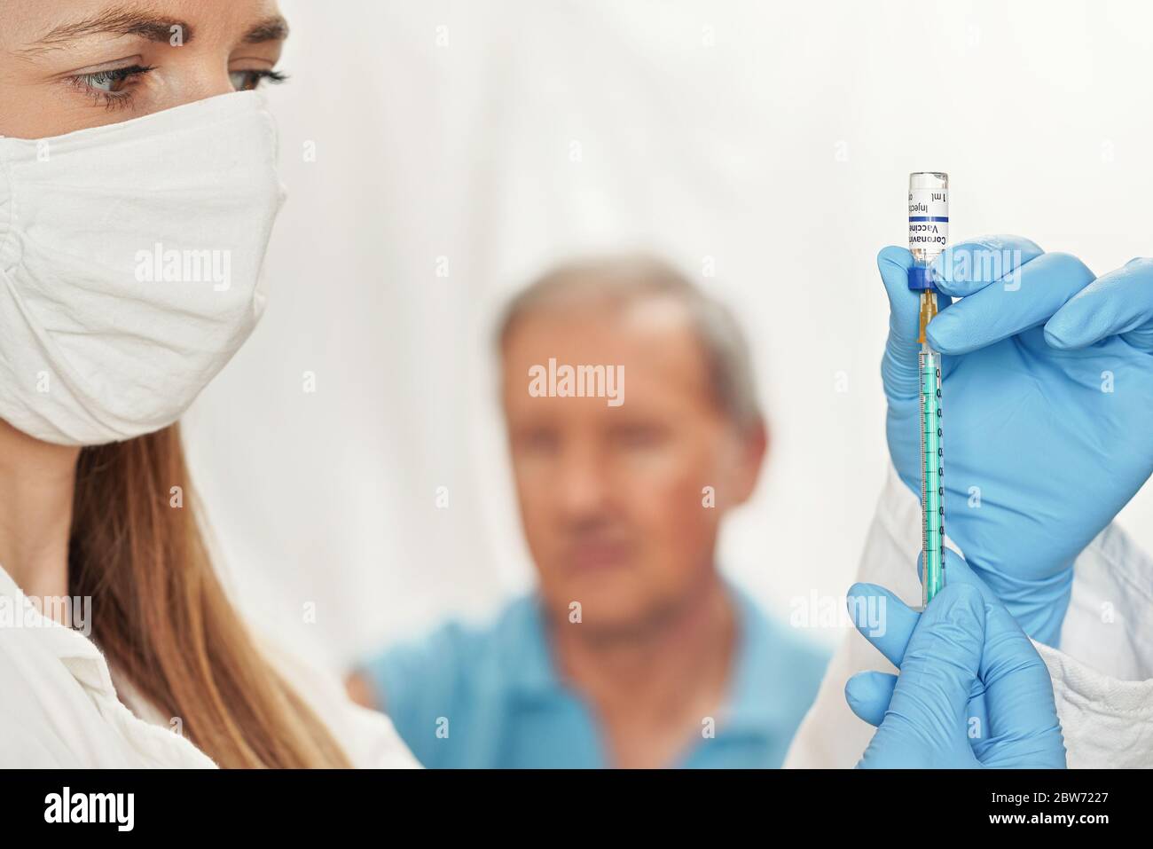 Young nurse with white cotton mouth virus face mask, injecting ...