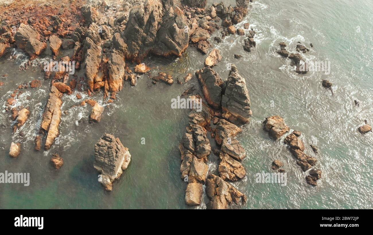 Aerial view rocks and stones on the Arambol beach in North Goa, India ...