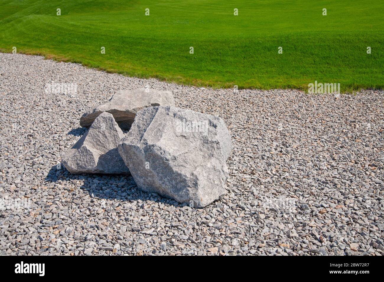 Landscaping, stones on gravel and lawn Stock Photo - Alamy