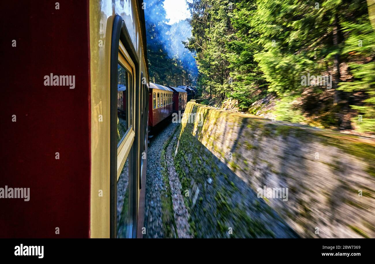 Steam locomotive drives through a curve in the forest. Dynamics through ...