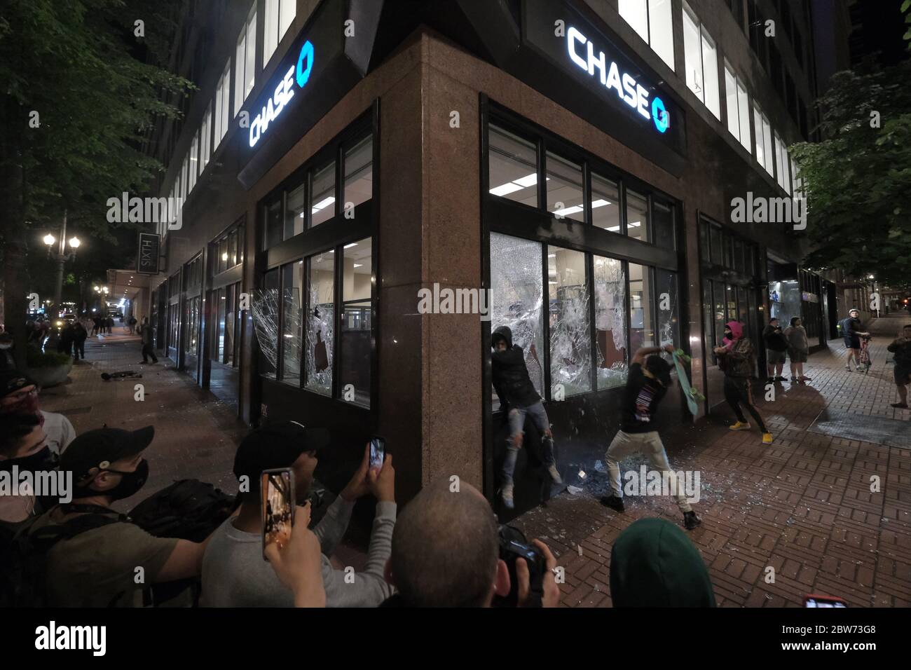 Protesters smash the windows of a Chase bank in Portland, Ore., on May ...