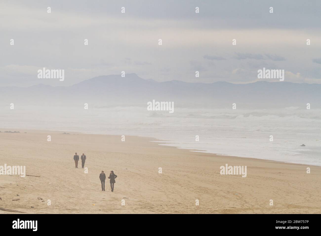 People walking on the beach. Social distancing Stock Photo - Alamy