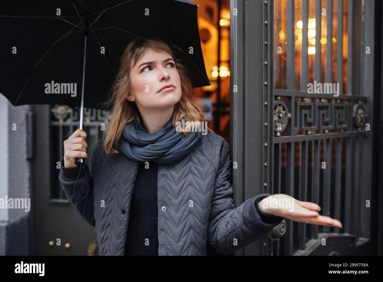 Sad lady standing on street with black umbrella Stock Photo - Alamy