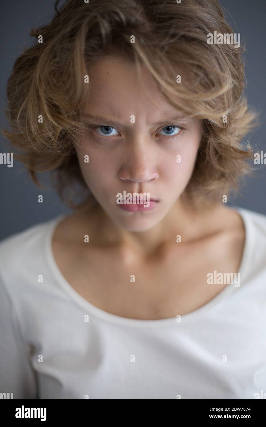 Portrait of young displeased lady angrily looking in camera Stock Photo ...