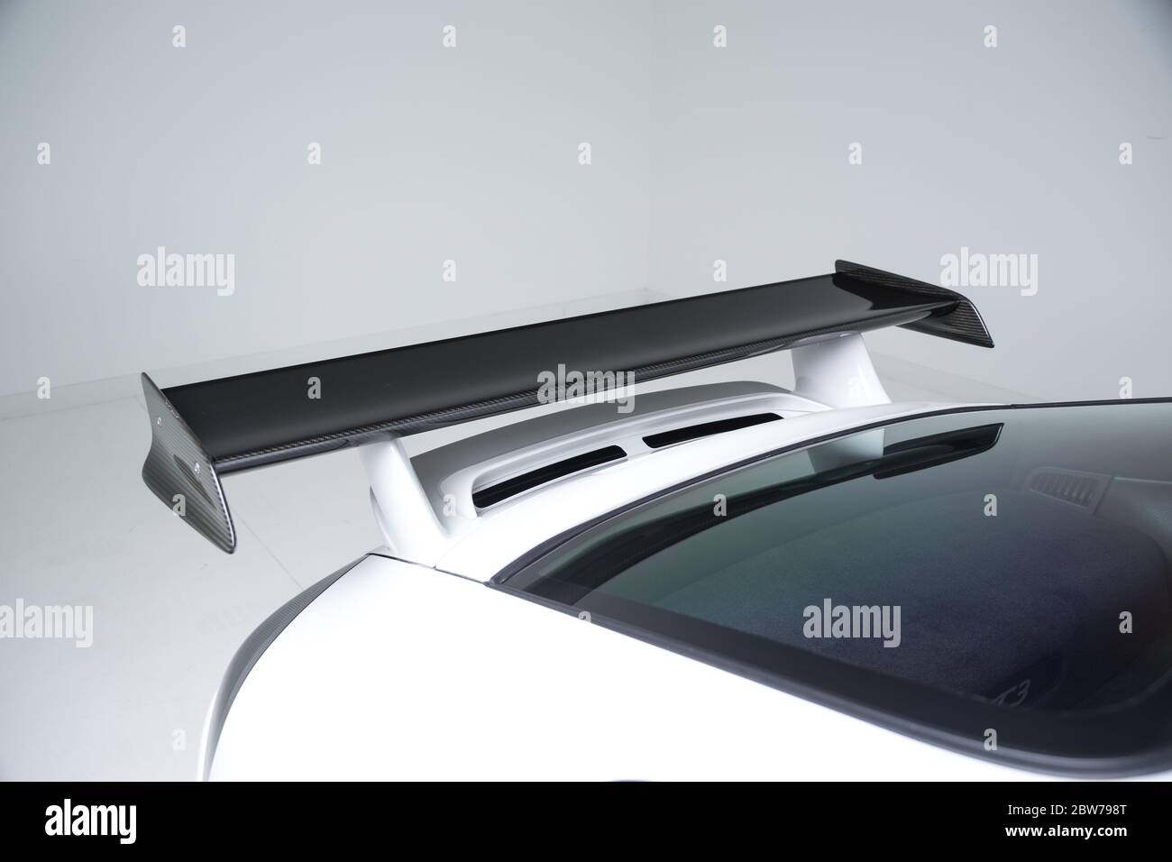 Spoiler on a white sports car Stock Photo - Alamy