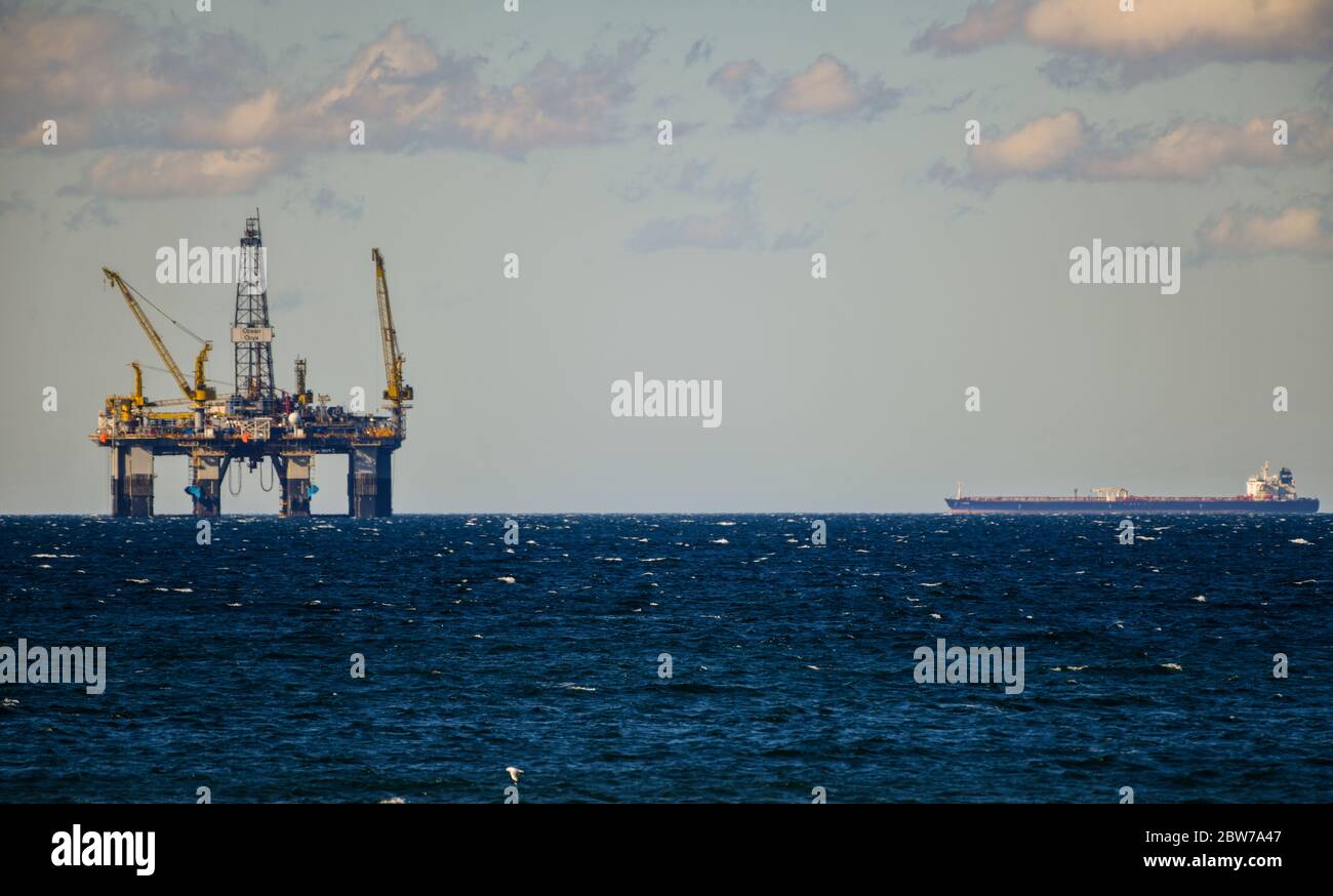 Oil Gas Drilling Rig Platform in Sea with blue ocean clouds and sunny ...