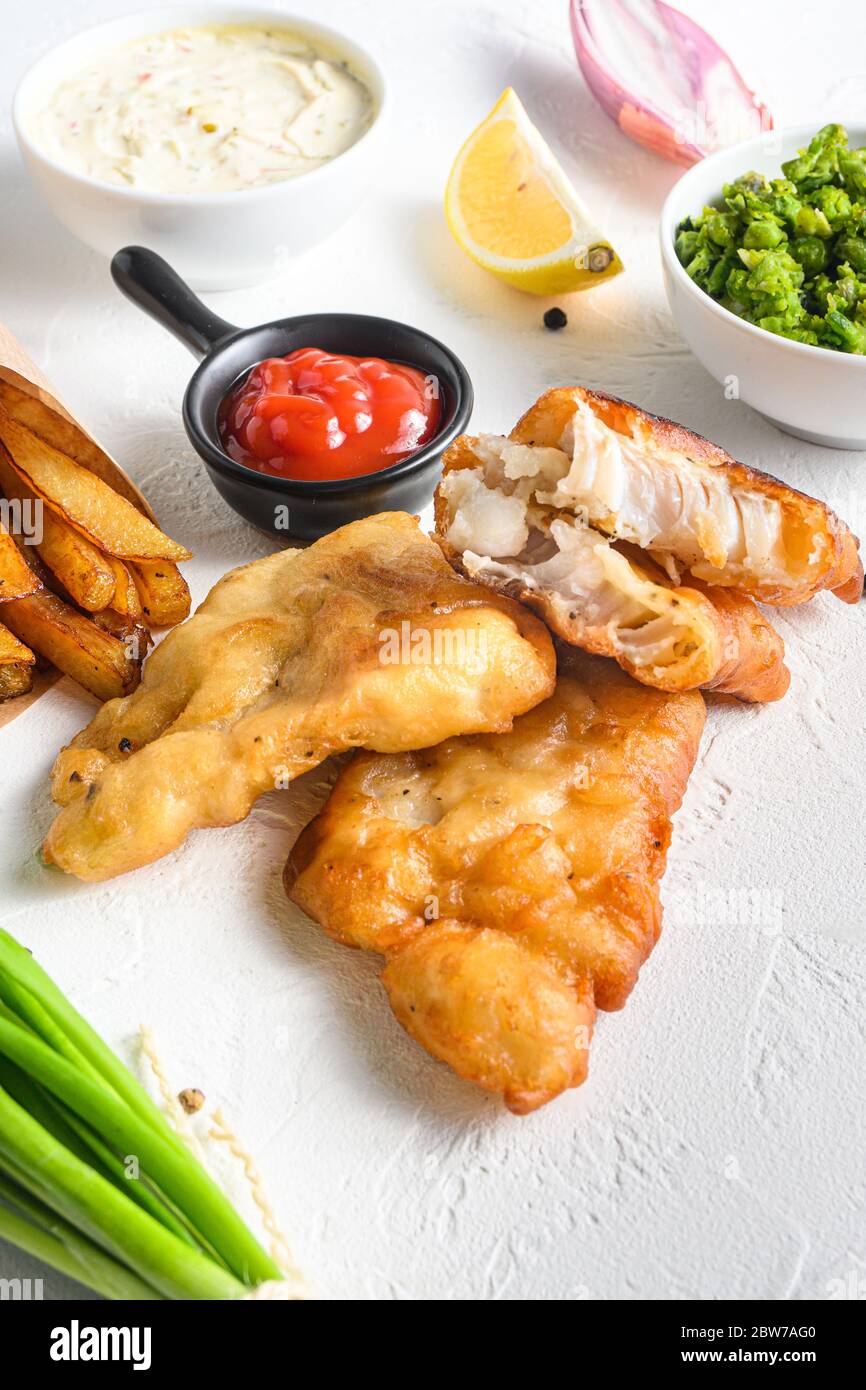 Fishand chips battered crispy cod fillet detail with dip and lemon in a ...