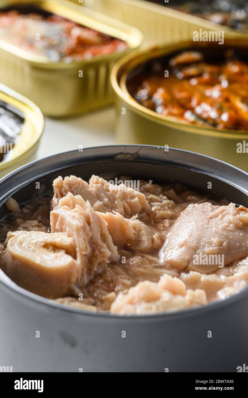Tuna tin can close up over Cans with different preserve of fish and ...