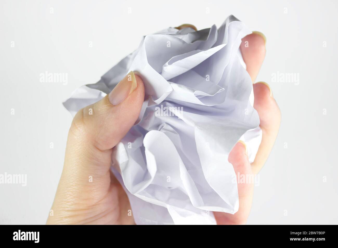 A woman's hand holds a crumpled paper ball with a copy of space on a ...