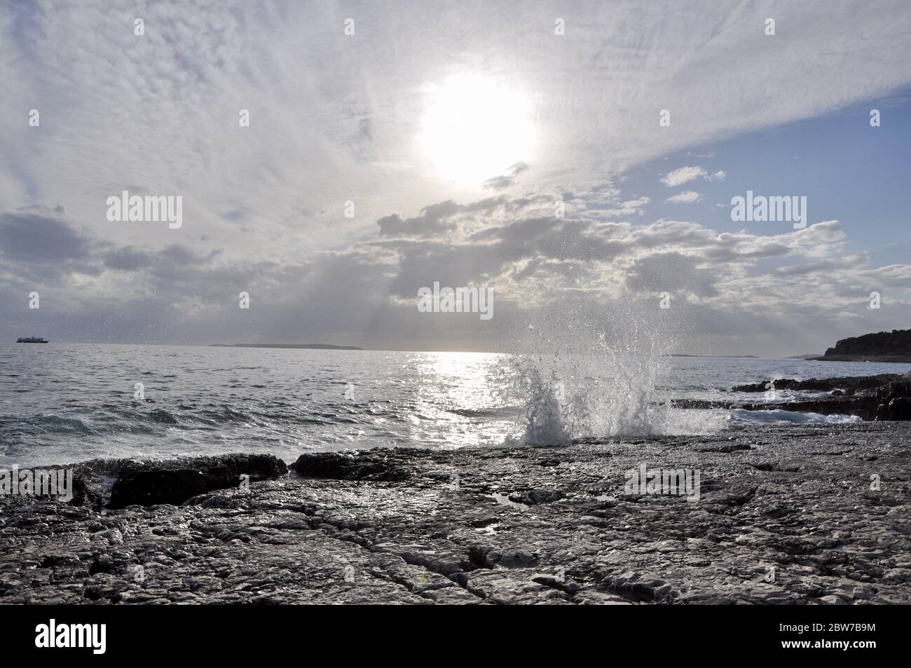 Wave hitting rocks. Wild sea waves at stormy weather Stock Photo - Alamy