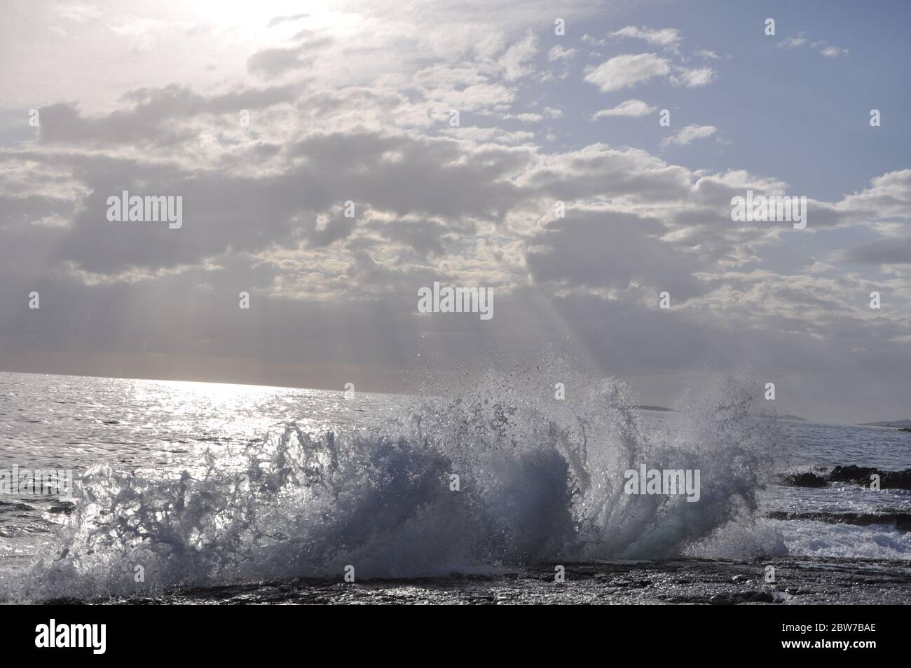 Wave hitting rocks. Wild sea waves at stormy weather Stock Photo - Alamy