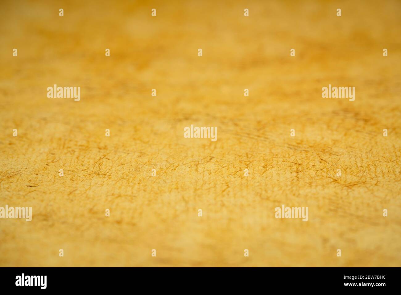background and texture of yellow huun handmade paper with a selective ...