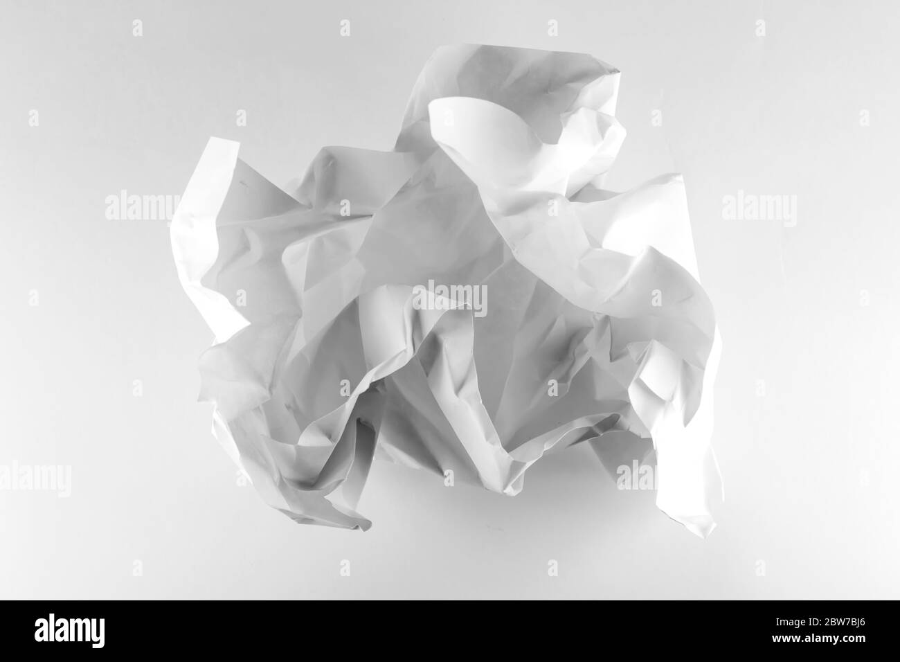 White crumpled paper ball on white background with clipping path. Close ...